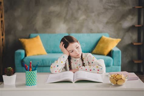Photo Of Adorable Small Girl Arm Touch Head Sad Think Study Homework Desktop Book Flat Indoors