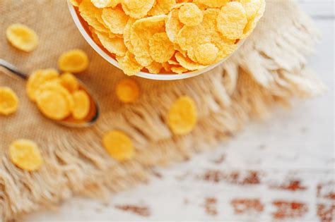 린 넨 위에 금색 플레이크가 있는 그릇 가벼운 나무 테이블 숟가락 옆에 소박한 시골 스타일입니다 위에서 보기 0명에 대한 스톡 사진 및 기타 이미지 Istock