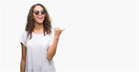 젊은 스페인 여자 선글라스 생기고 엄지 측면 가리키는 행복 한 얼굴로 미소를 착용 T 셔츠에 대한 스톡 사진 및 기타 이미지 T 셔츠 가리키기 갈색 머리 Istock