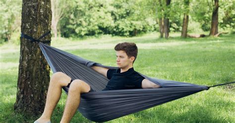 나무 사이에서 해먹에서 차가워지는 청년 사회적 거리 두기 여름 공원에서 사회적 거리를두고 피크닉에서 대화를 즐기는 소수의 사람들 사진 Unsplash의 풀 이미지