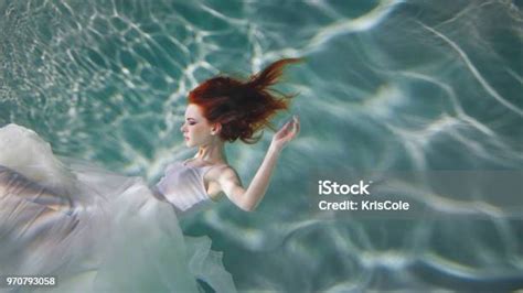 수 중 소녀입니다 아름 다운 빨간 머리 여자는 하얀 드레스를 입고 물 속에서 수영 수중에 대한 스톡 사진 및 기타 이미지