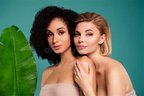 Photo Of Two Girls Touch Embrace Feel Tenderness Near Green Exotic Leaves Cyan Color Background