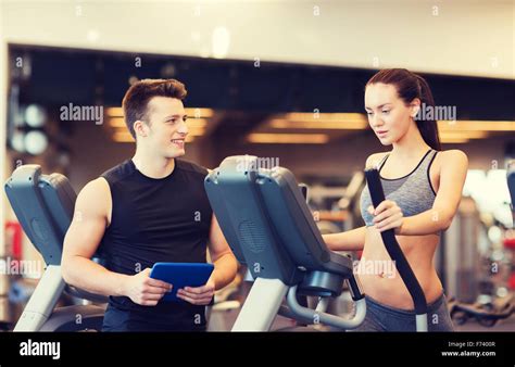 Woman With Trainer Exercising On Stepper In Gym Stock Photo Alamy