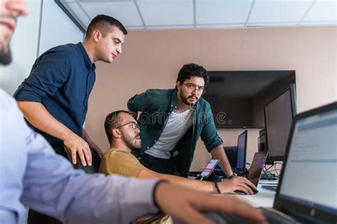 Collaborative Minds A Team Of Programmers Tackling Challenges Together In The Office Stock