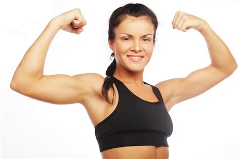 Premium Photo Young Sporty Woman Flexing Her Biceps