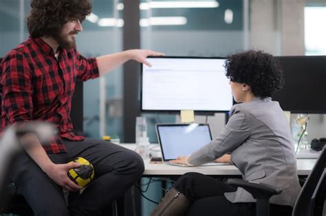 Premium Photo Young Software Developers Couple Using Laptop And Desktop Computer While Writing