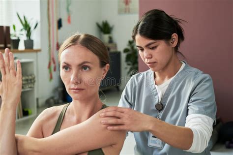 Performing Physical Therapy On Female Patient By Professional Therapist