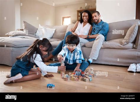 Siblings Are There To Help Each Other Out Two Young Siblings Playing With Their Toys While