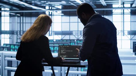 Team Of Developers Doing Maintenance Checkup Using Laptop To Prolong Data Center Hardware Life