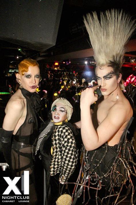 Two Women Dressed Up In Costumes Standing Next To Each Other