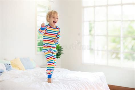 Ni O Jugando En La Cama Sala De Ni Os Beb En Casa Imagen De Archivo Imagen De Divertido