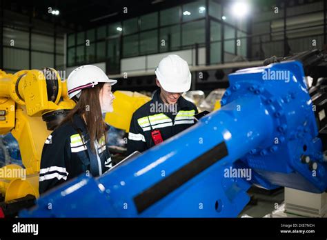 Both Of Engineers Working Together In A Robotic Arm Factory Robotic Arm Industry And