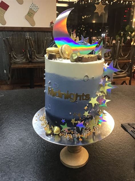 Midnight Cake With Blue And White Decor And Rainbow Stars