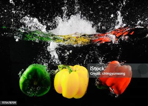 신선한 녹색 노란색 붉은 피망과 아테르 스플래시와 거품이 분리되어 있습니다 다채로운 복사 공간 검은 색 배경에 떨어지는 세 가지 색깔의 파프리카 0명에 대한 스톡 사진 및