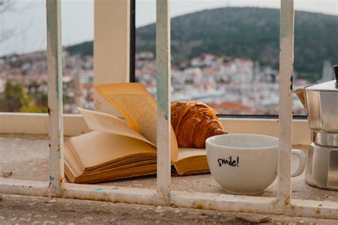 커피 책 크루아상과 함께하는 아늑한 아침 · 무료 스톡 사진
