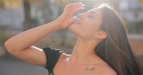 Slow Motion Beautiful Brunette Woman Touch Her Hair In Sun Light Stock