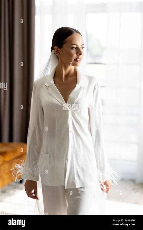 Beautiful Bride Wearing White Pajamas And Veil Getting Ready For