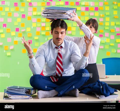 Man And Woman In The Office With Many Conflicting Priorities In Yoga Concept Stock Photo Alamy
