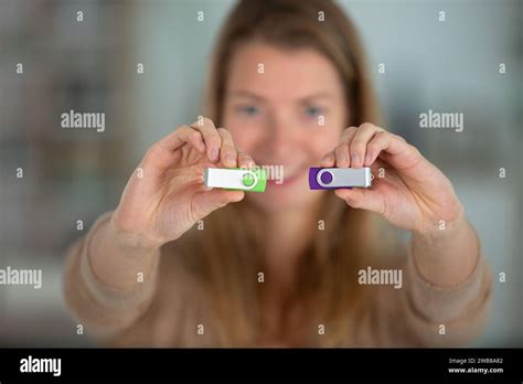 A Brunette Holding 2 Usb Keys Stock Photo Alamy