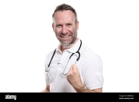 Enthusiastic Unshaven Middle Aged Doctor Punching The Air With His Fist