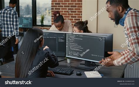 1 Mixed Programer Team Working On Group Project On Multiple Screens Showing Running Code Startup