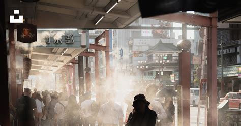 한 남자가 자전거를 타고 많은 사람들 옆 거리를 달리고 있습니다 사진 Unsplash의 무료 도쿄 이미지