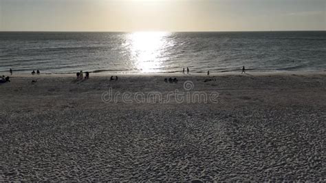 Ariel Shot Of The Sunlight Creating A Shimmering Path Across Calm Waters Marco Island Shoreline