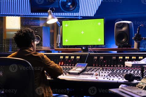 African American Sound Designer Works With Greenscreen Monitor Mixing And Mastering Tracks On