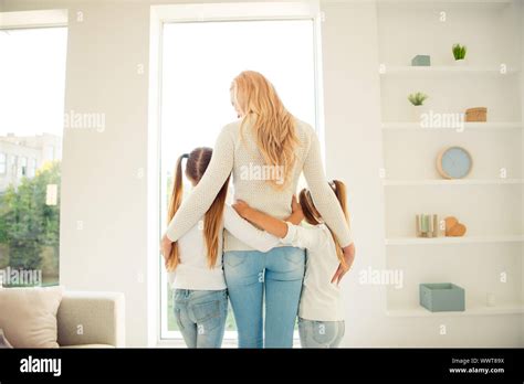 Rear Back Behind View Of Nice Adorable Stylish Trendy Slim People Mom Mommy Mum Girls Hugging In