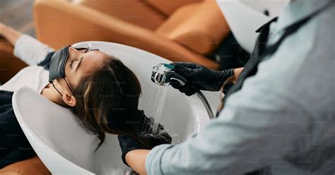 코로나바이러스 팬데믹 기간 동안 미용실에서 일하는 동안 여성의 머리를 씻는 미용사의 클로즈업 사진 Unsplash의 세르비아 이미지