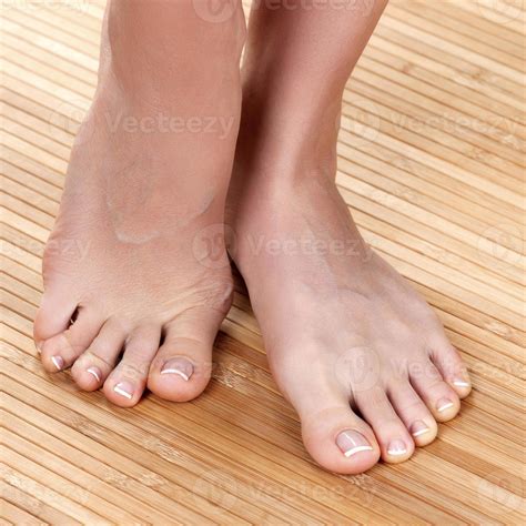 Beautiful Female Feet On A Wooden Floor Closeup Shot Stock Photo At Vecteezy