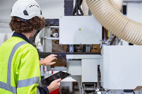 Young Worker Control Operate Wood Cutter Cnc Machine In Furniture