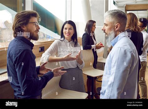 Group Of People Communicating And Sharing Opinions At A Business Meeting In The Office Stock