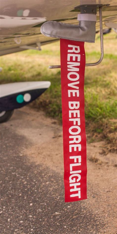 Remove Before A Flight Is A Safety Warning Commonly Seen On Removable Aircraft And Spacecraft