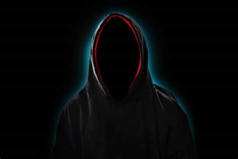 130 hooded computer hacker in the shadow with binary codes stock