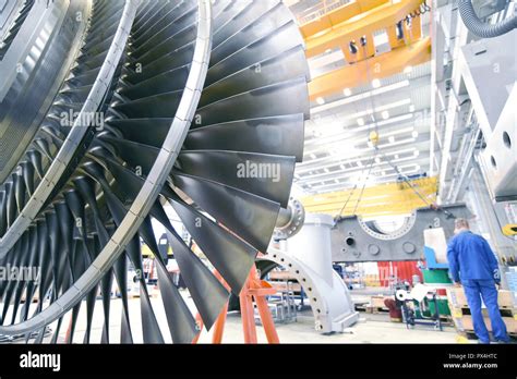 Workers Assembling And Constructing Gas Turbines In A Modern Industrial