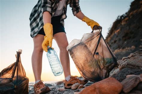 Global Environmental Pollution Woman Volunteer Holding A Polyethylene Bag And Picks Up A