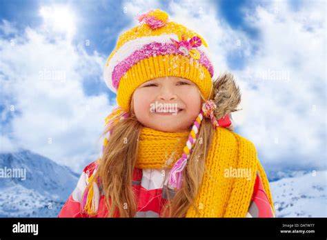 Face Portrait Of Happy Girl On Winter Day Wearing Yellow Clothes Stock