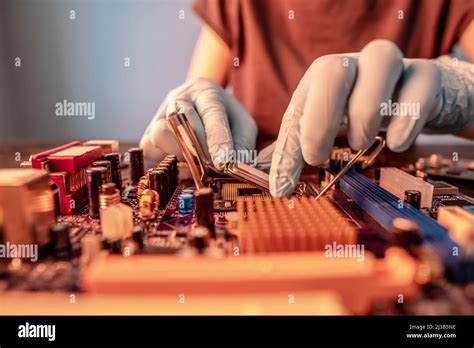 Engineer Repairman Holding Hands In Black Gloves Chip Processor Cpu To Insert Into The Socket