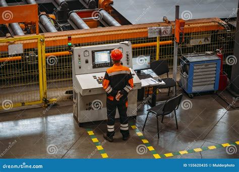 Factory Worker Monitoring Cnc Machine In Metalworking Workshop