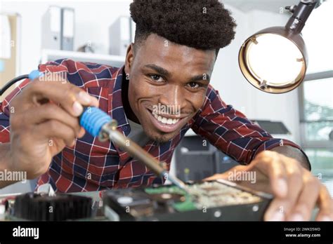 Happy Man Repairing The Computer Laptop Stock Photo Alamy