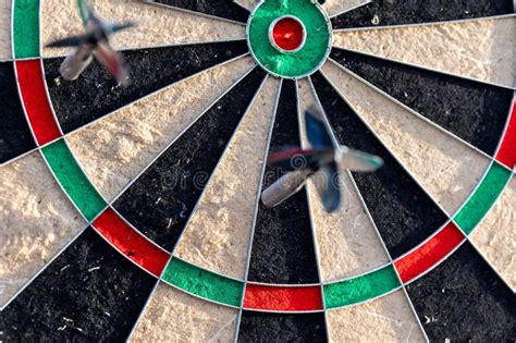 a closeup portrait of a part of a dart board game with two darts