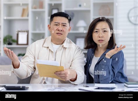Supermarket Employee Checking Product Labeling On Shelves At Grocery Store Female Retail Worker