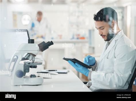 Making Informed Decisions Based Off His Thorough Research A Young Scientist Using A Digital