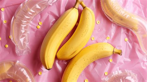 Condoms And Two Bananas Together Concept Of Contraceptives Background