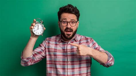 A Man Pointing At A Clock That Says He Is Pointing At It Premium AI Generated Image