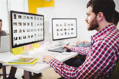 Side View Of Editor Working On Photos At Creative Office Stock Image