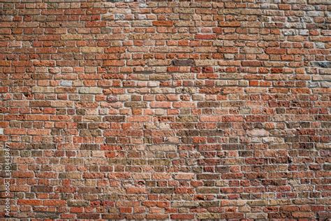 Texture Of A Medieval Brick Wall Of Burgundy Red And Brown Bricks