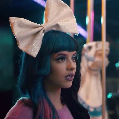 A Woman With Black Hair Wearing A White Bow On Top Of Her Head In Front