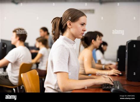 Teenage Girl Learning To Use Personal Computer During Lesson Stock Photo Alamy